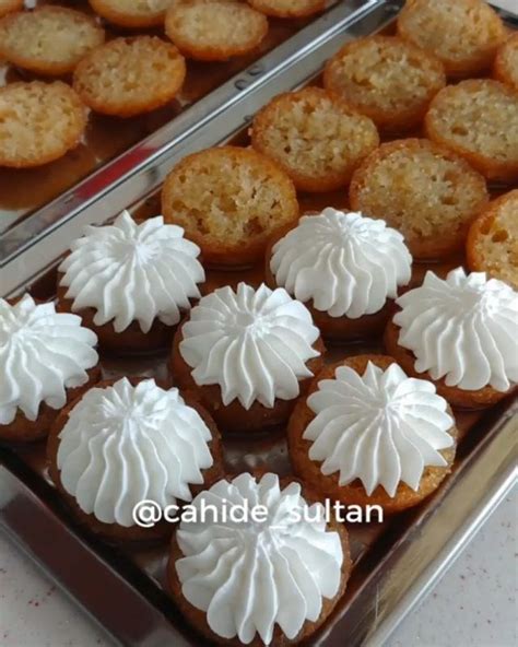 There Are Many Cupcakes With White Frosting On Them