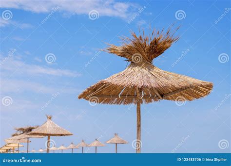 Straw Beach Umbrellas On The Seashore Stock Photo Image Of Heat Blue