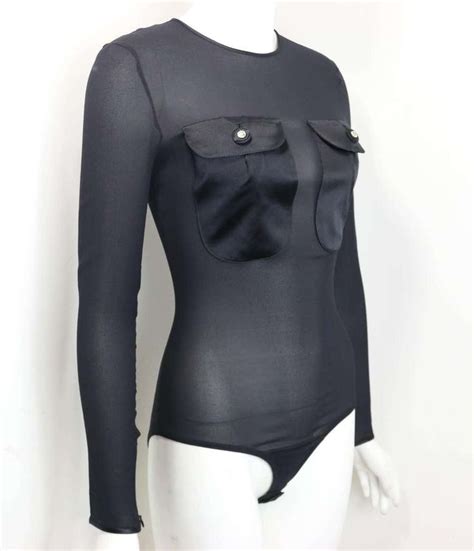A Mannequin Wearing A Black Bodysuit With Long Sleeves And Buttons On