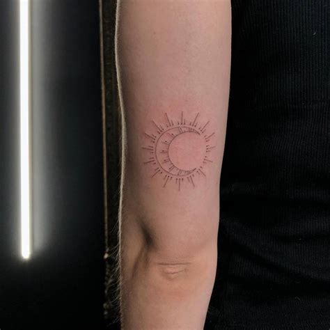 Fine Line Sun And Moon Tattoo On The Tricep