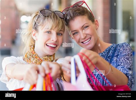 Beautiful Women Holding Shopping Bags Looking At Camera Stock Photo Alamy