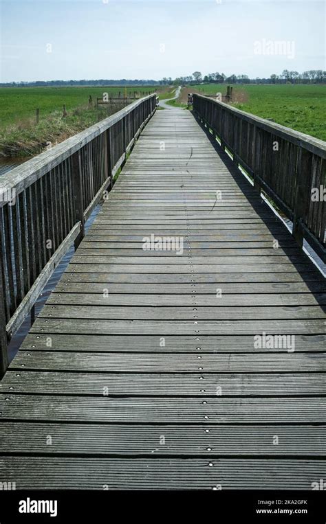 Pedestrian Bridge Passes Over A Moat Filled With Water Against The