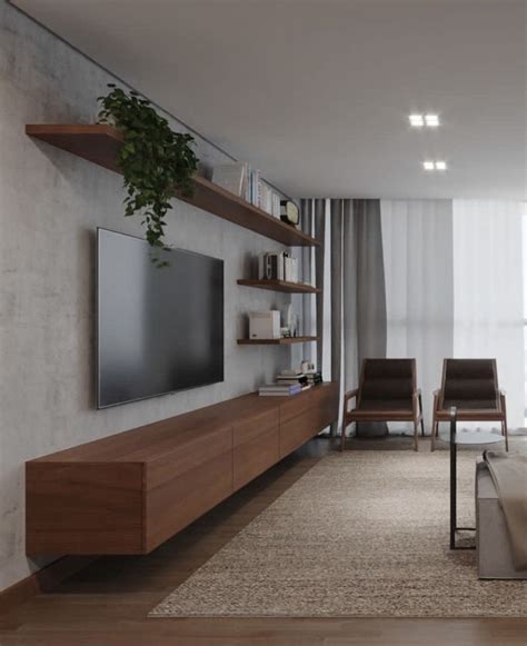 A Living Room Filled With Furniture And A Flat Screen Tv On Top Of A