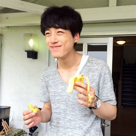 A Man Holding Two Bananas In His Hands
