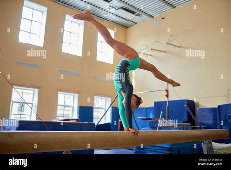 Girl Athlete Doing Handstand On Balance Beam Stock Photo Alamy
