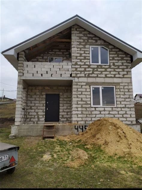 A Large Pile Of Dirt In Front Of A House