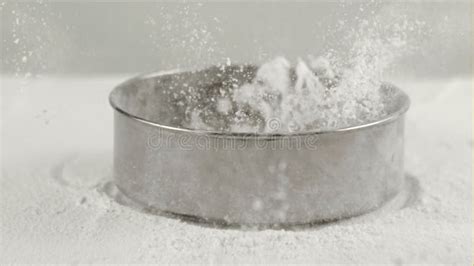 A Sieve Of Flour Falls On The Kitchen Table Filmed On A High Speed