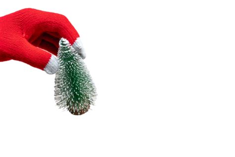 Uma árvore De Natal Está Sendo Colocada Em Uma Mesa Por Uma Mão