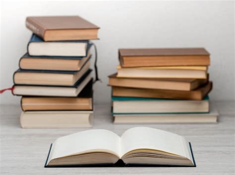 Premium Photo Stack Of Vintage Books On Wooden Desk With Open Book