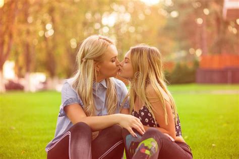 Stylish Woman With Daughter Kissing On Lawn Stock Photo Image Of