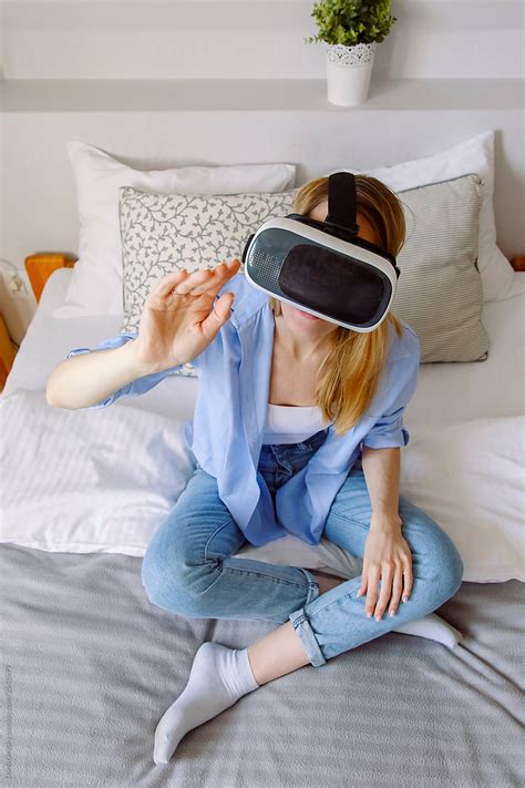 Woman Exploring Virtual Reality On Bed Del Colaborador De Stocksy Danil Nevsky Stocksy