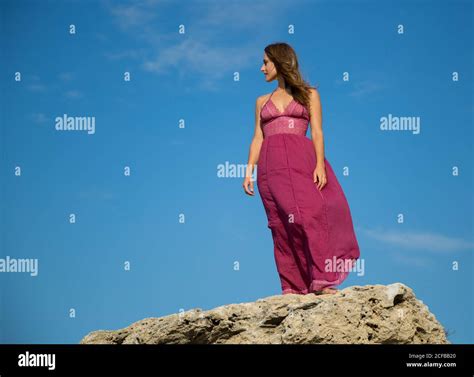 Woman In Dress Standing Near Stone Monument Stock Photo Alamy