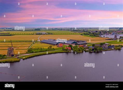 Aerial From A Typical Dutch Landscape With Windmills Water En Far