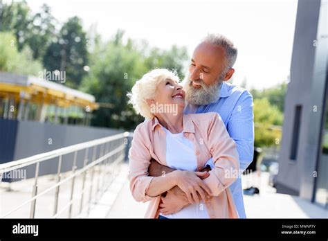 Portrait Of Happy Senior Man Hugging Wife On Street Stock Photo Alamy
