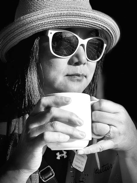 Premium Photo Woman Wearing Sunglasses And Hat While Holding Coffee Cup