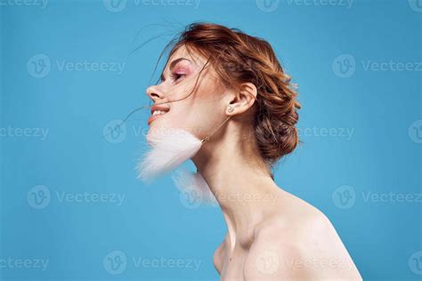 Pretty Woman Naked Shoulders And Fluffy Earrings Bright Makeup Blue