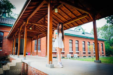 Building Standing Asian Model Women Dark Hair Smiling White Dress