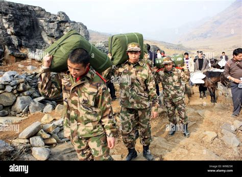 Chinese Paramilitary Policemen And Other Rescuers Transport Relief
