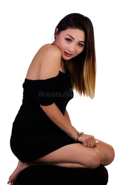 Attractive Asian American Woman Kneeling In Black Dress On White Stock Image Image Of