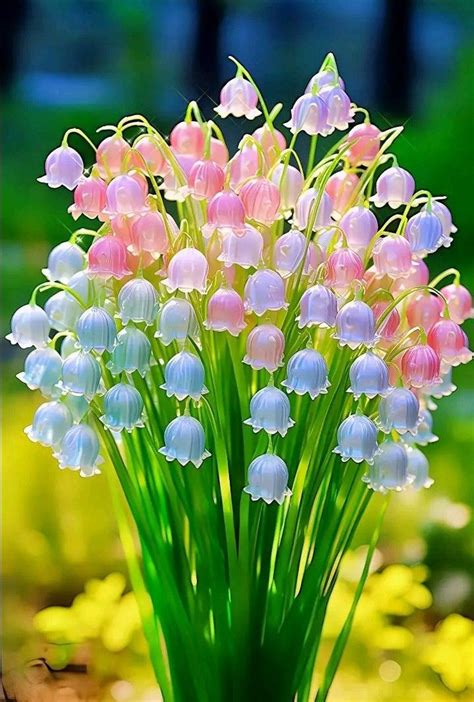 A Vase Filled With Pink And White Flowers On Top Of A Green Planter