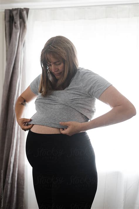 Full Term Pregnant Woman Changing Clothes Del Colaborador De Stocksy