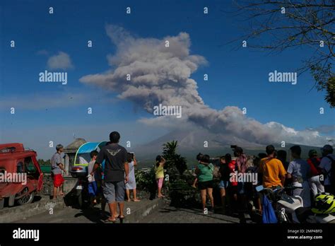 Residents Watch As Mayon Volcano Spews Ash Anew During Its Eruption For