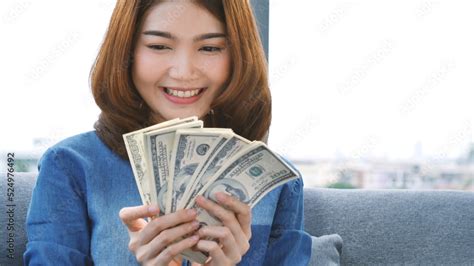 Happy Young Asian Woman Holding Dollar Money And Throw In The Air Celebrate Happiness Dance
