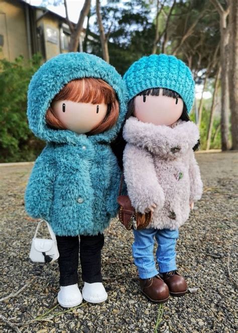 Two Dolls Are Standing Next To Each Other