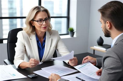 Mature Business Woman Manager Discussing Documents Looking At Partner
