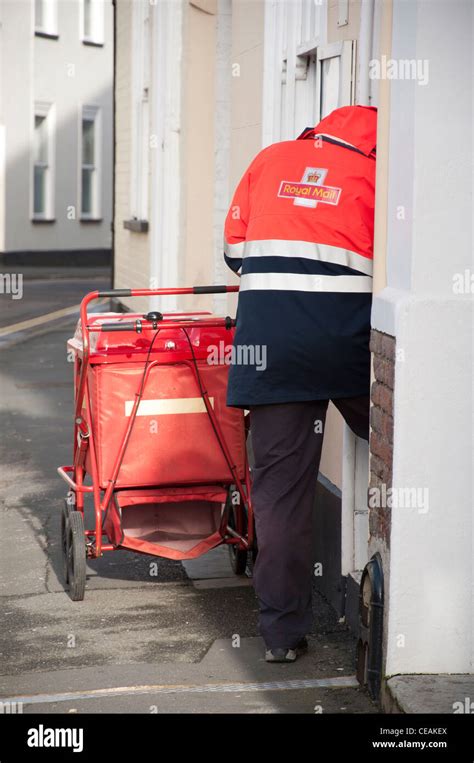 Royal Mail Postman Delivering Letters With A Trolley Stock Photo Alamy