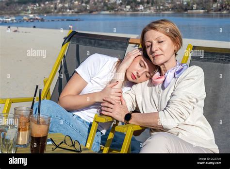 Mother And Daughter Spending Quality Time Together By The River The Mother Comforts Her Sad