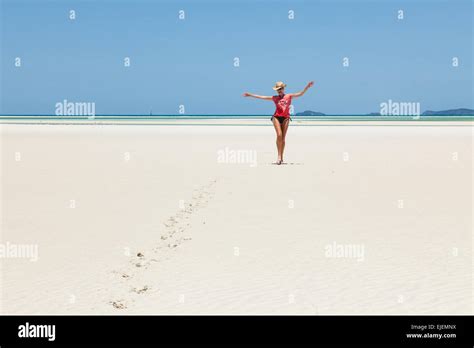 A Mature Woman Walking On The White Sands Of Whitehaven Beach In