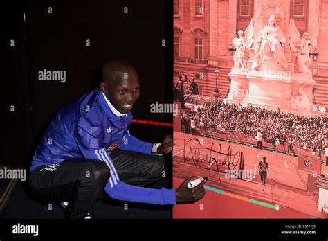 Wilson Kipsang Signas A Photo Of Himself At The Virgin Money London