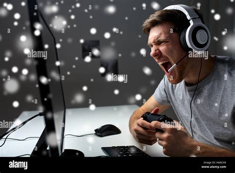 Man In Headset Playing Computer Video Game At Home Stock Photo Alamy