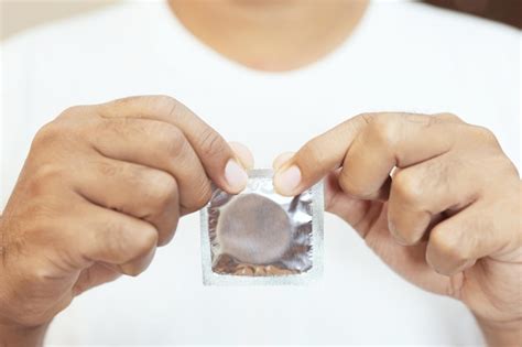 Premium Photo Midsection Of Man Holding Condom