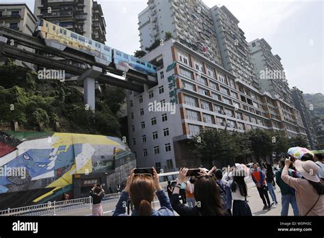 File People Take Pictures Or Videos Of A Monorail Train Driving Into