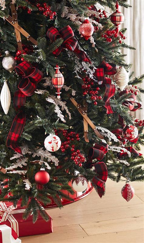 The Christmas Tree Is Decorated With Red And White Ornaments