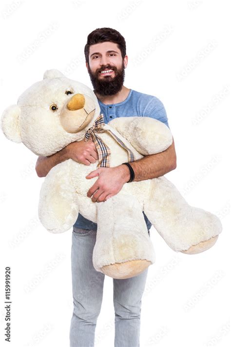 He S A Hopeless Romantic Handsome Man Holding Teddy Bear While Smiling