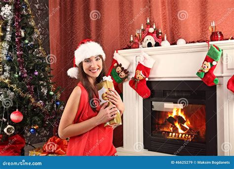 Beautiful Woman Near The Fireplace In Winter House Selebrating