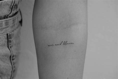 Rise And Bloom Lettering Tattoo On The Inner Forearm