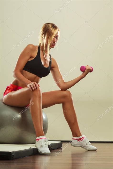 Woman With Gym Ball And Dumbbell Doing Exercise Stock Photo By