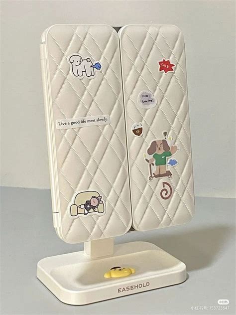 An Electronic Device With Stickers On The Front And Back Sides Sitting