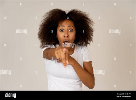 Beautiful Shocked African American Woman Looking And Pointing At Something Unbelievable Or