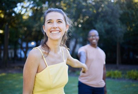 Premium Photo Interracial Couple Holding Hands And Park With Happiness Romance And Bonding