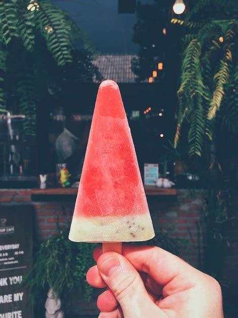 Premium Photo Cropped Hand Holding Ice Cream Cone