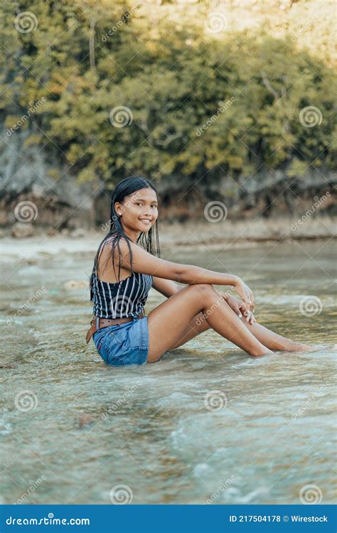 Portrait Of A Beauitful Brown Skin Filipina Model On A White Sand Beach In The Philippines Stock