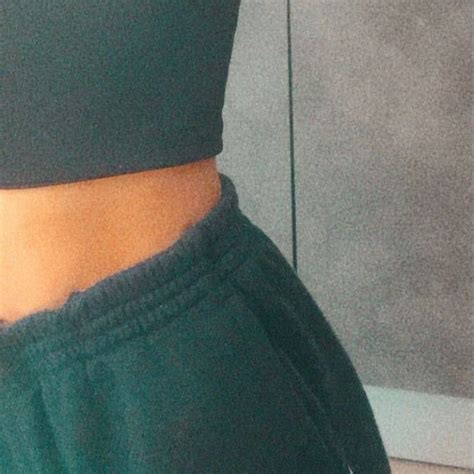 The Bottom Half Of A Woman S Green Sweatpants