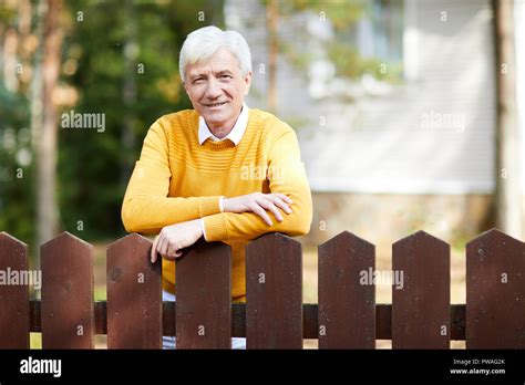 Man Leaning Against Wooden Fence Hi Res Stock Photography And Images