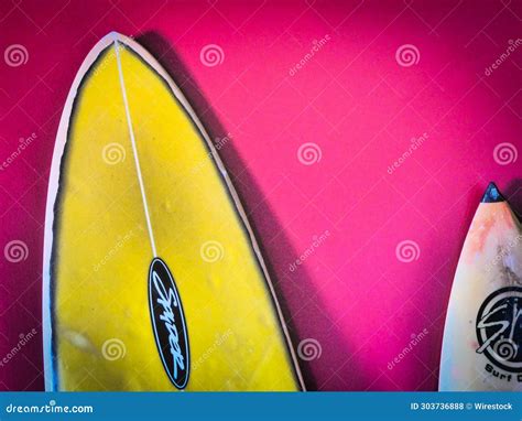 Colorful Photo Of Two Surfboards Leaning Against A Wall Stock Photo