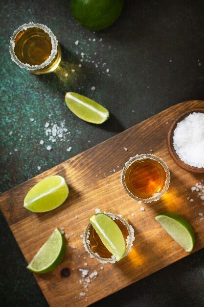 Premium Photo Mexican Gold Tequila Shot With Lime And Salt On Dark